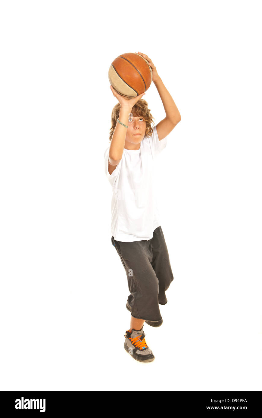 Young boy throwing basketball isolated on white background Stock Photo ...