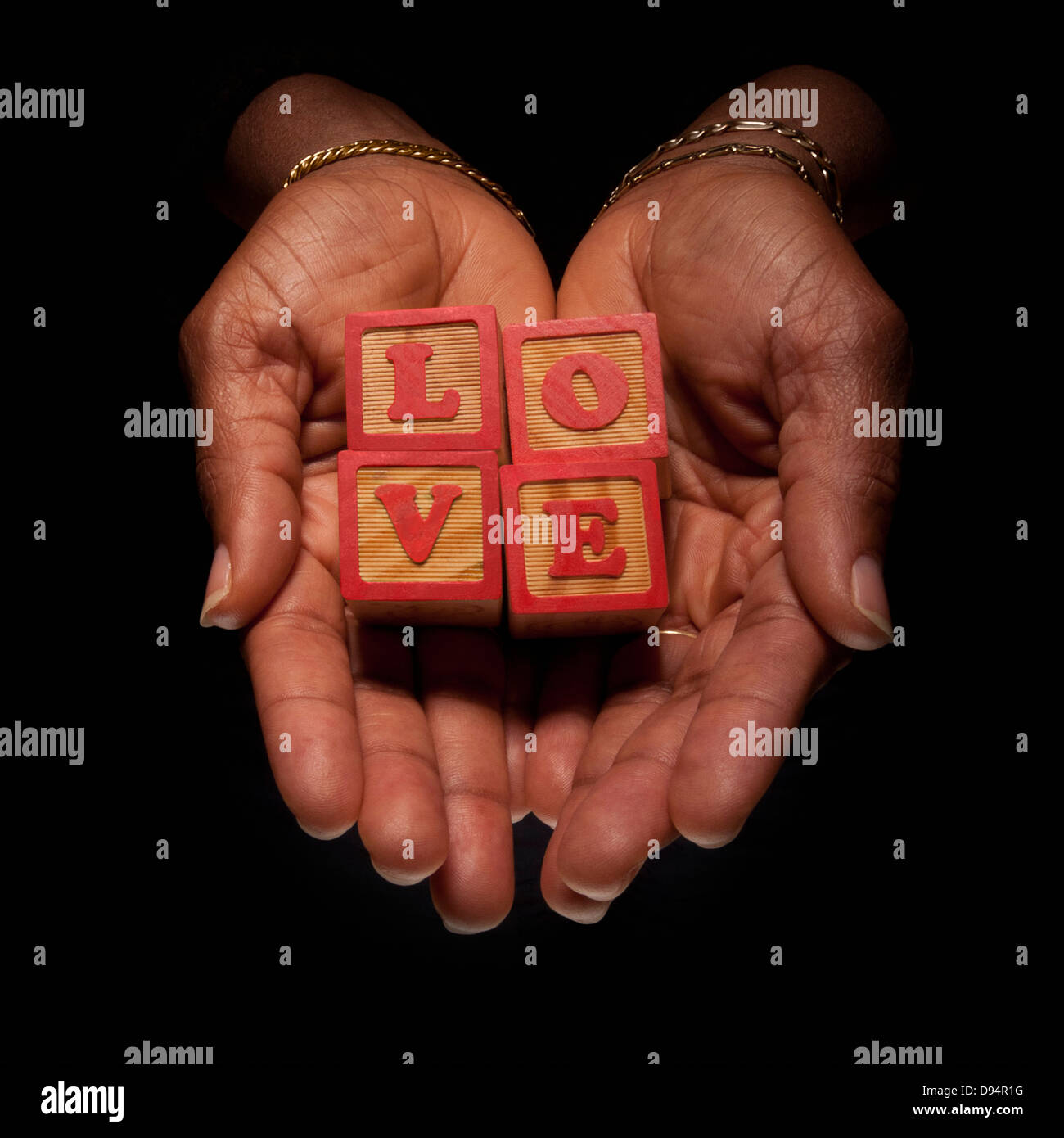 Close-up of Woman's Hands holding Wooden Blocks spelling LOVE, Studio ...