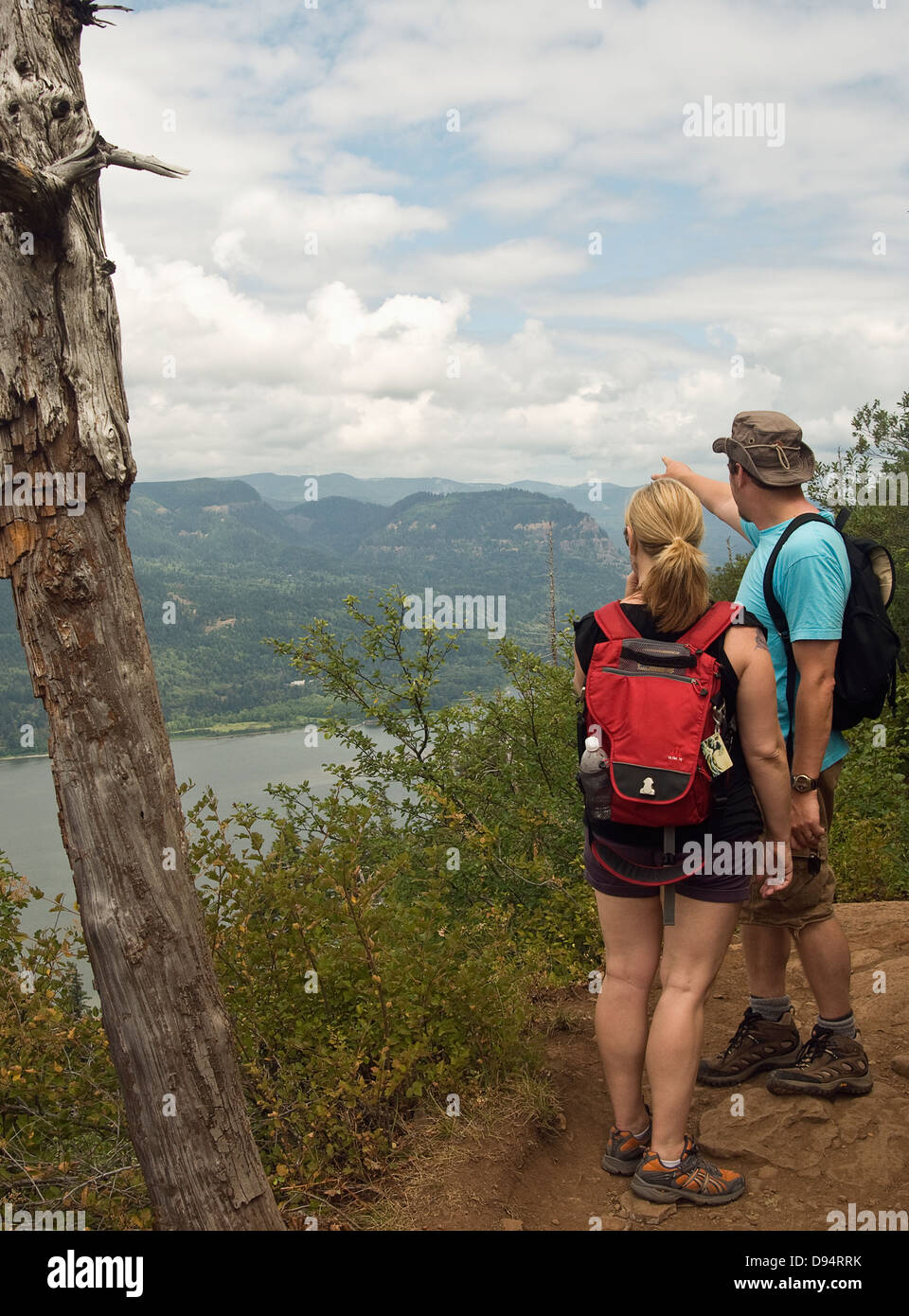 two hikers on the trail up to angels rest in the Columbia River Gorge ...