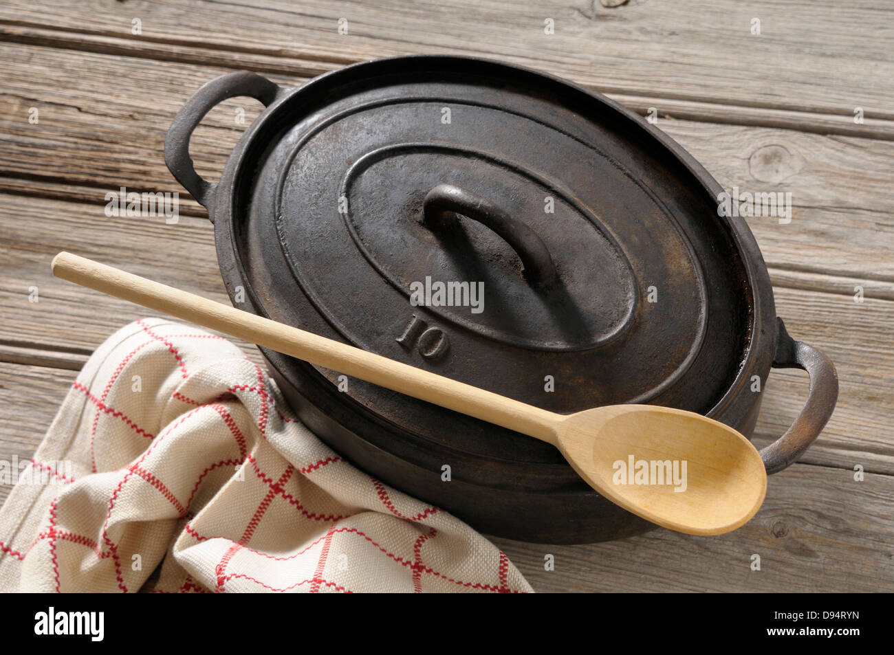 Overhead View of Cast Iron Cooking Pot with Wooden Spoon and Tea Towel ...