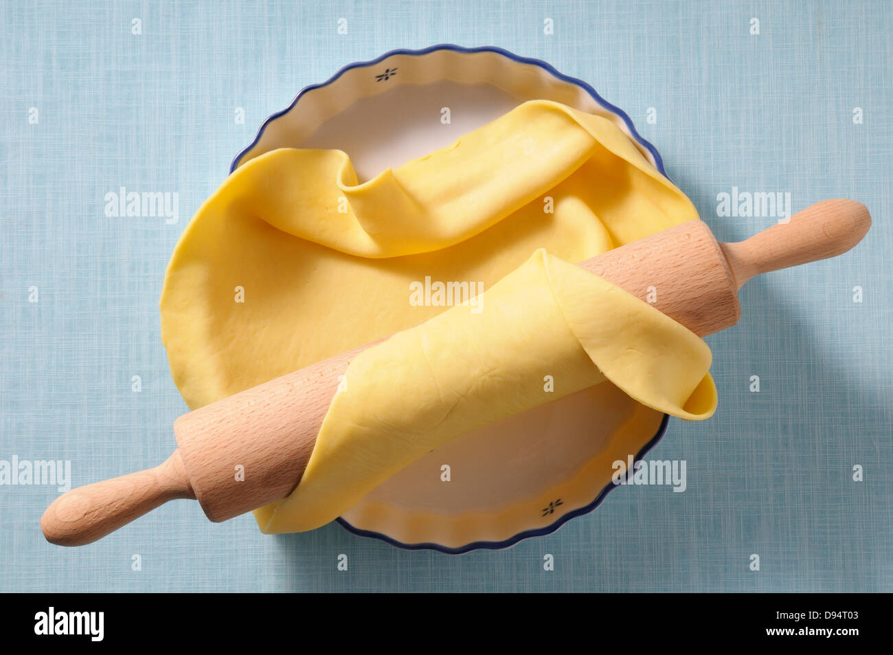 Overhead View of Pie Crust in Pie Plate and Rolling Pin on Blue ...
