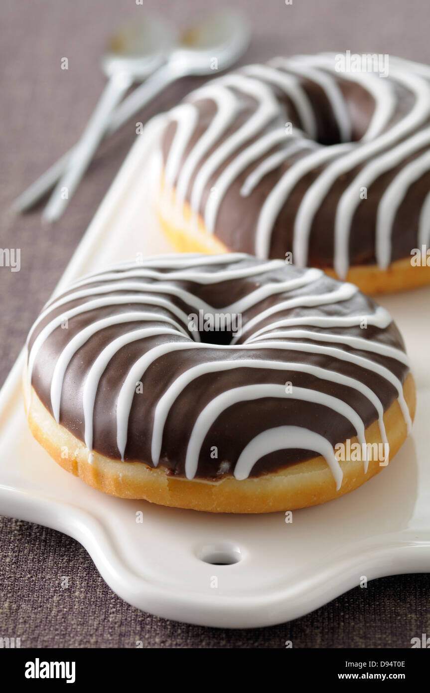 Close-up of Chocolate Dipped Donut with Vanilla Stripes on Cutting ...