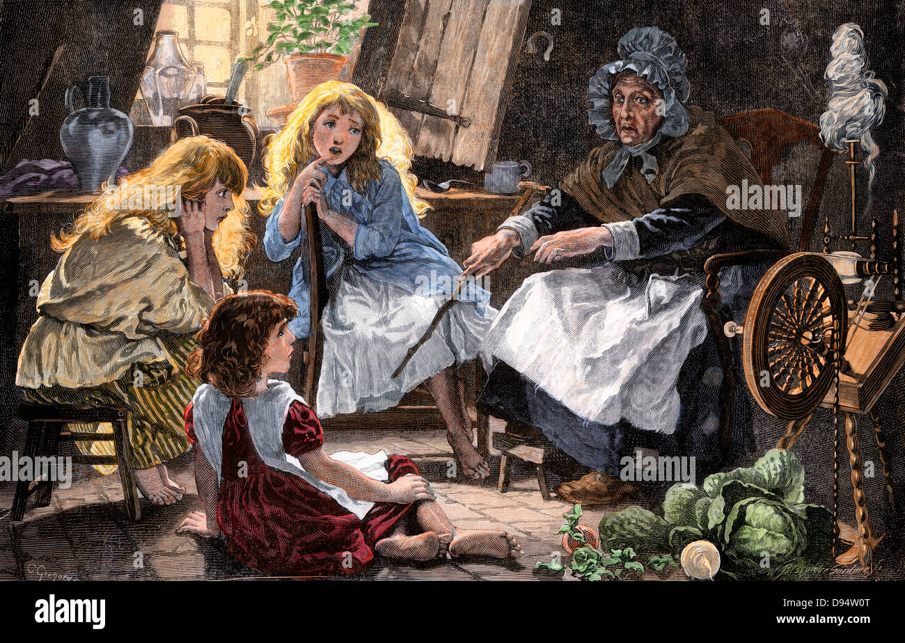 Old woman telling stories to girls in a cottage kitchen, England. Hand ...