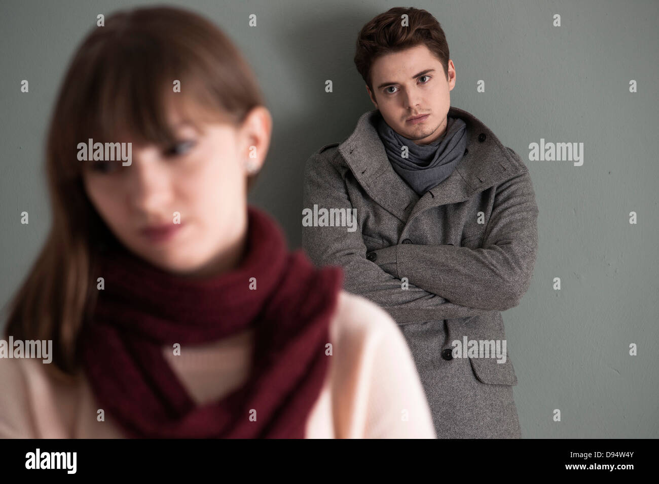 Portrait of Young Man Standing behind Young Woman, Looking at her ...