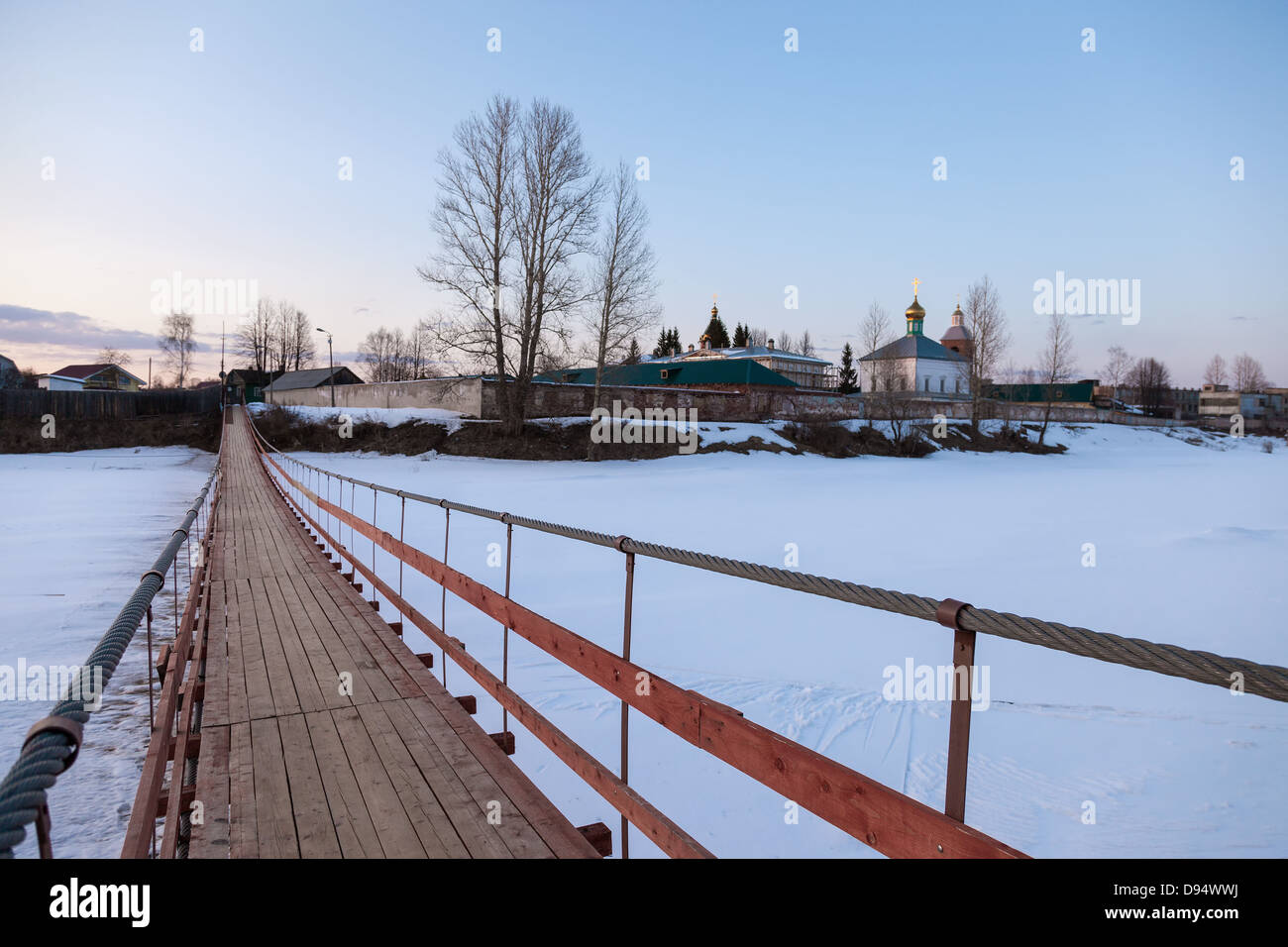 Suspension foot bridge over the frozen river Stock Photo - Alamy