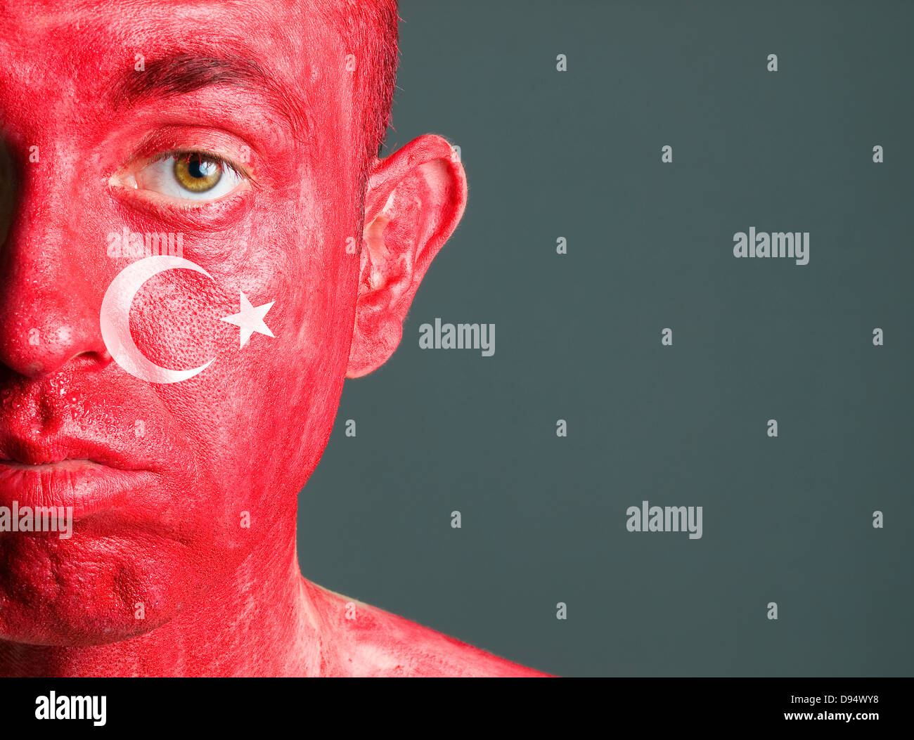 Face man turkish flag, isolated on dark background and looking at ...