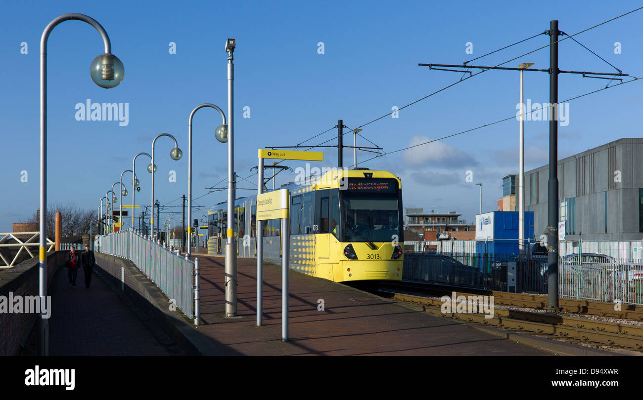 Manchester yellow Tram leaves the station Stock Photo - Alamy