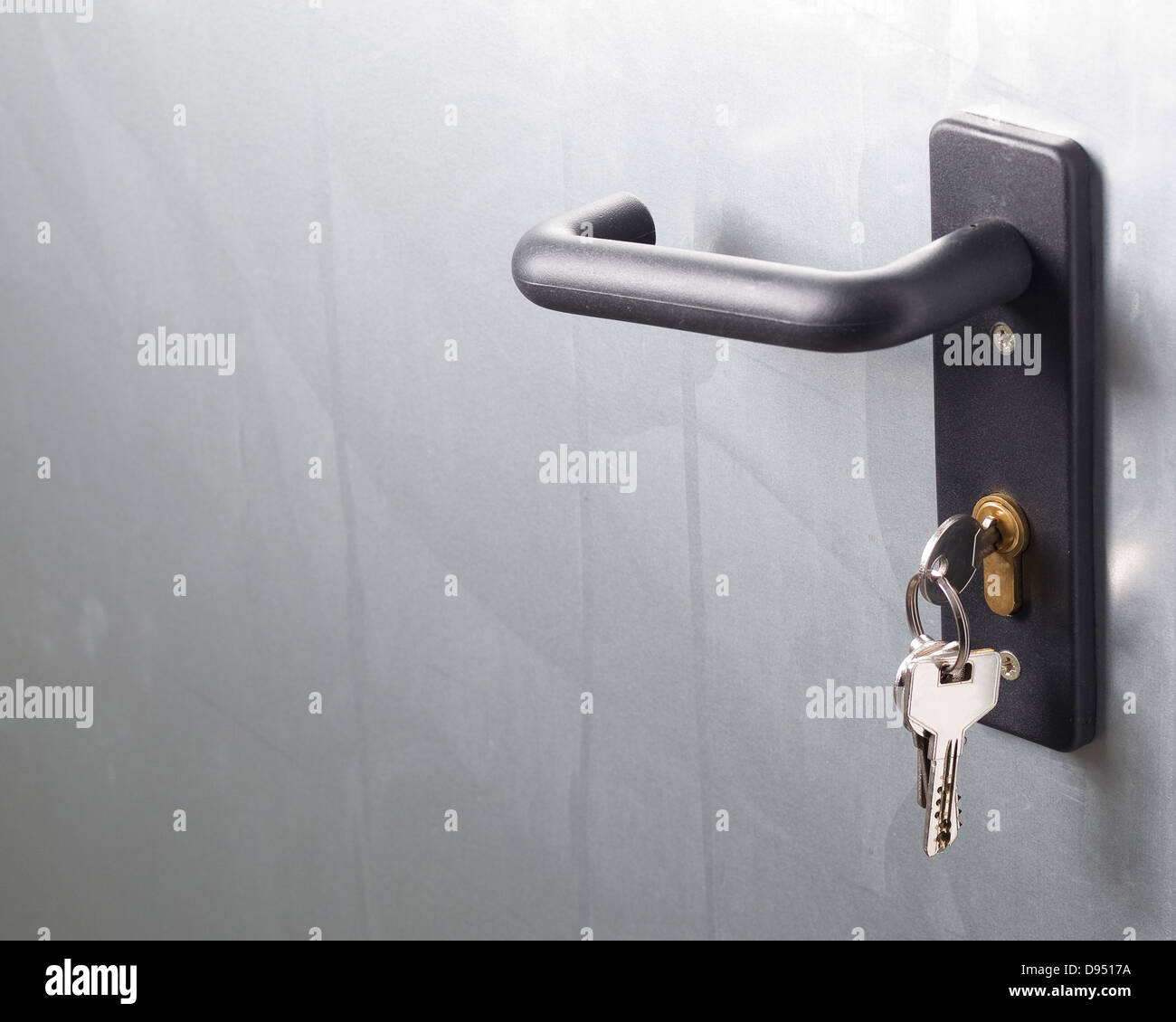 A door handle with lock and keys. The door is metallic Stock Photo - Alamy