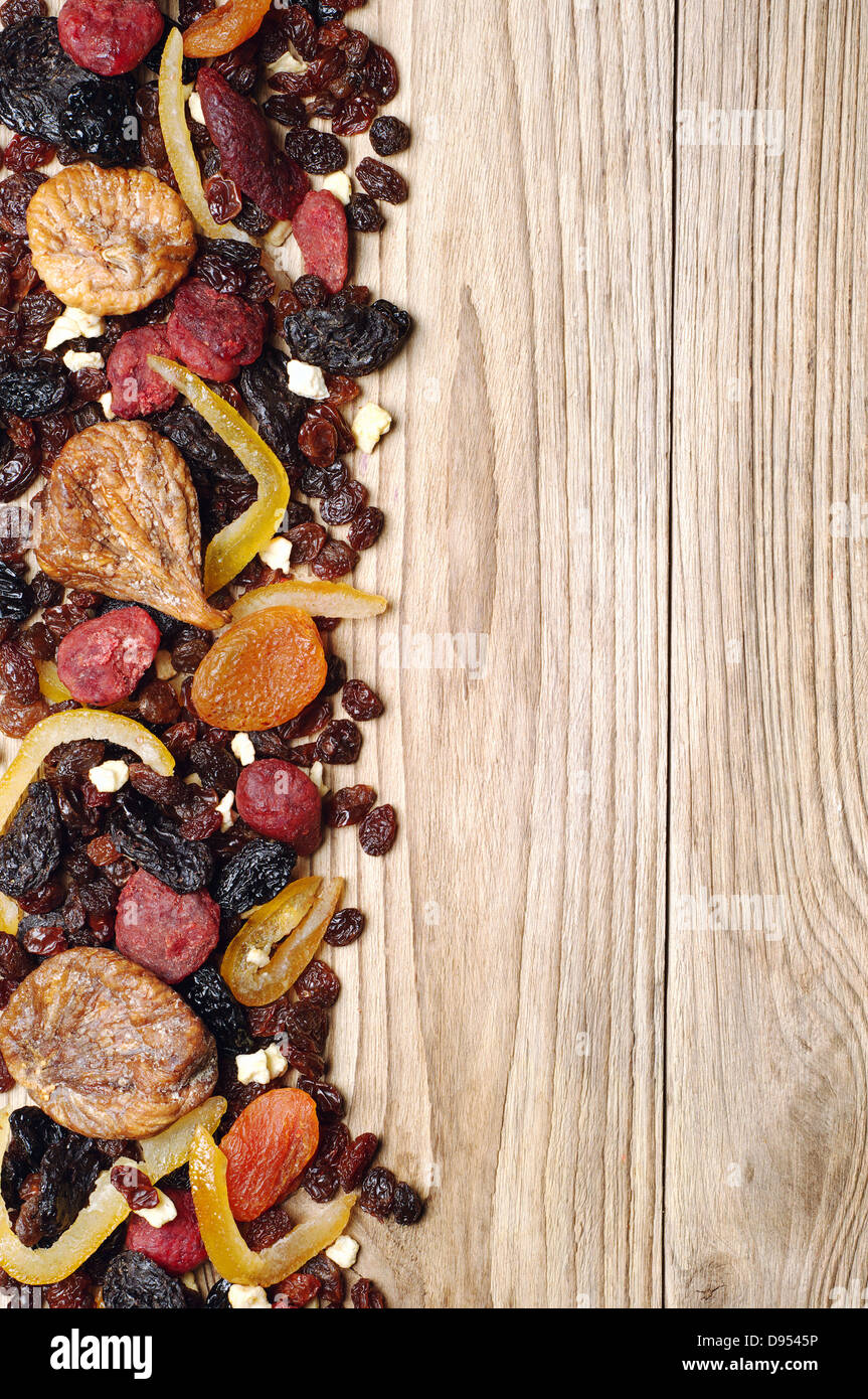 Background with dried fruits on wooden table Stock Photo - Alamy