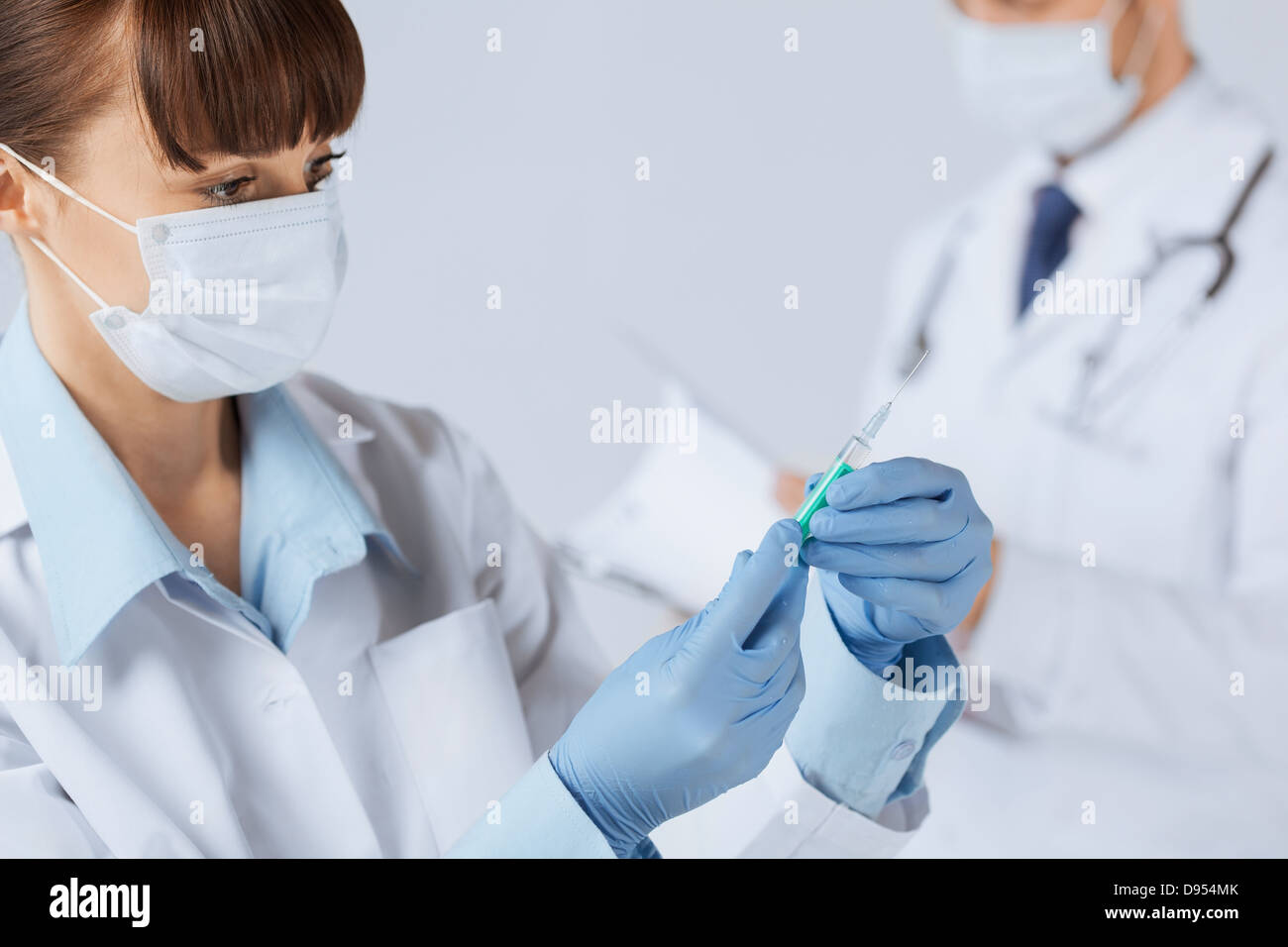 female doctor holding syringe with injection Stock Photo - Alamy