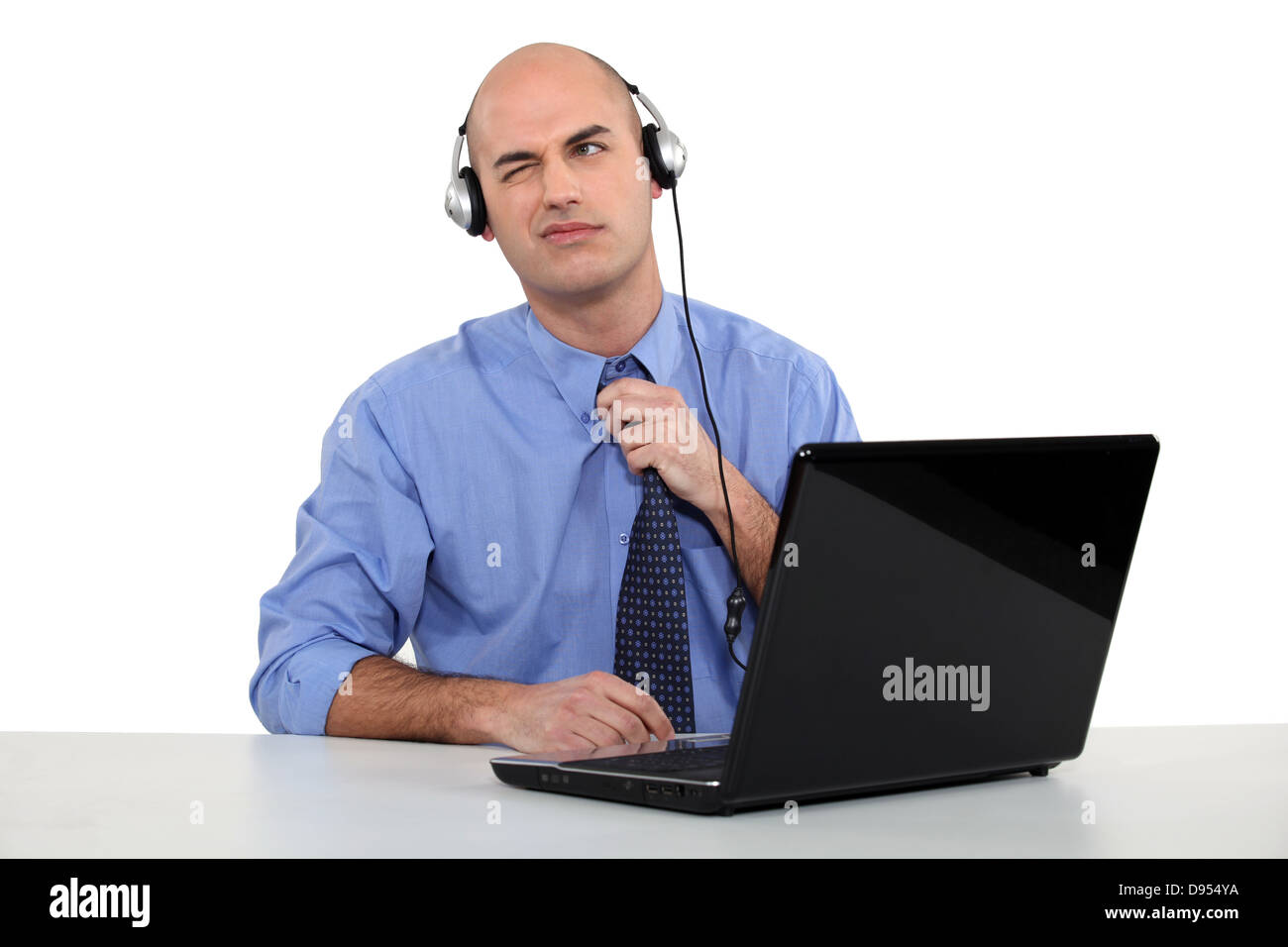 Man wearing headphones in front of his laptop Stock Photo - Alamy
