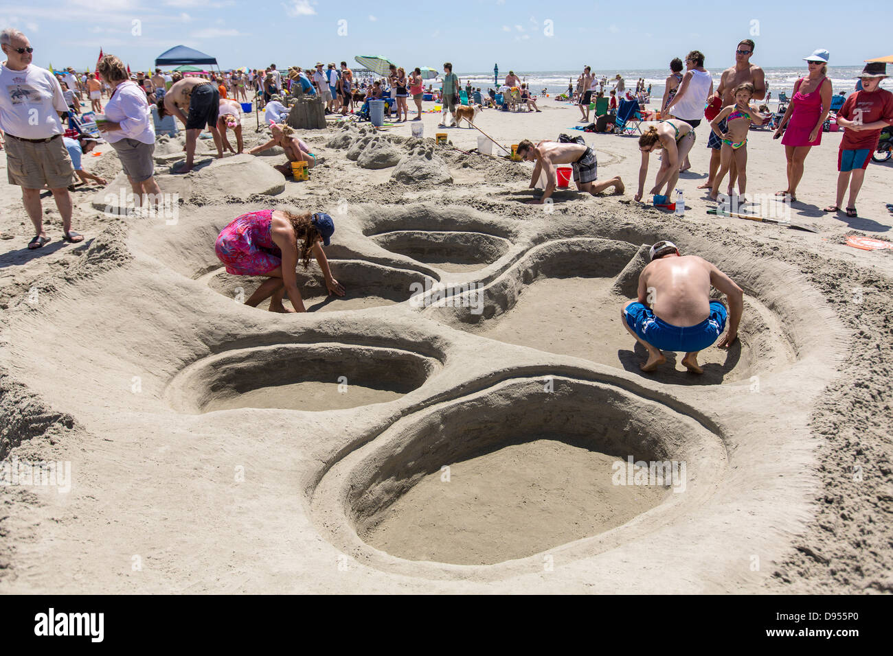 Contestants work on creating sand sculptures during the Spoleto ...