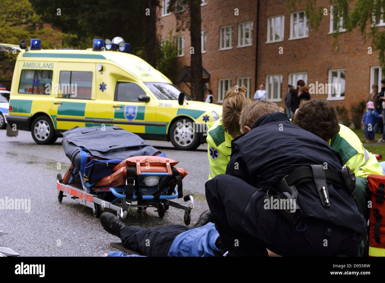 Swedish paramedics preparing a patient for transport to the hospital in ...