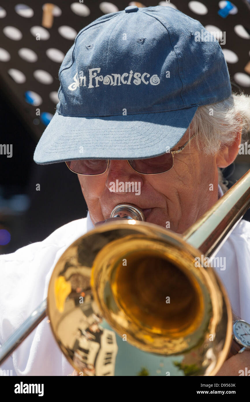 close up of male trombone player in baseball cap Stock Photo - Alamy