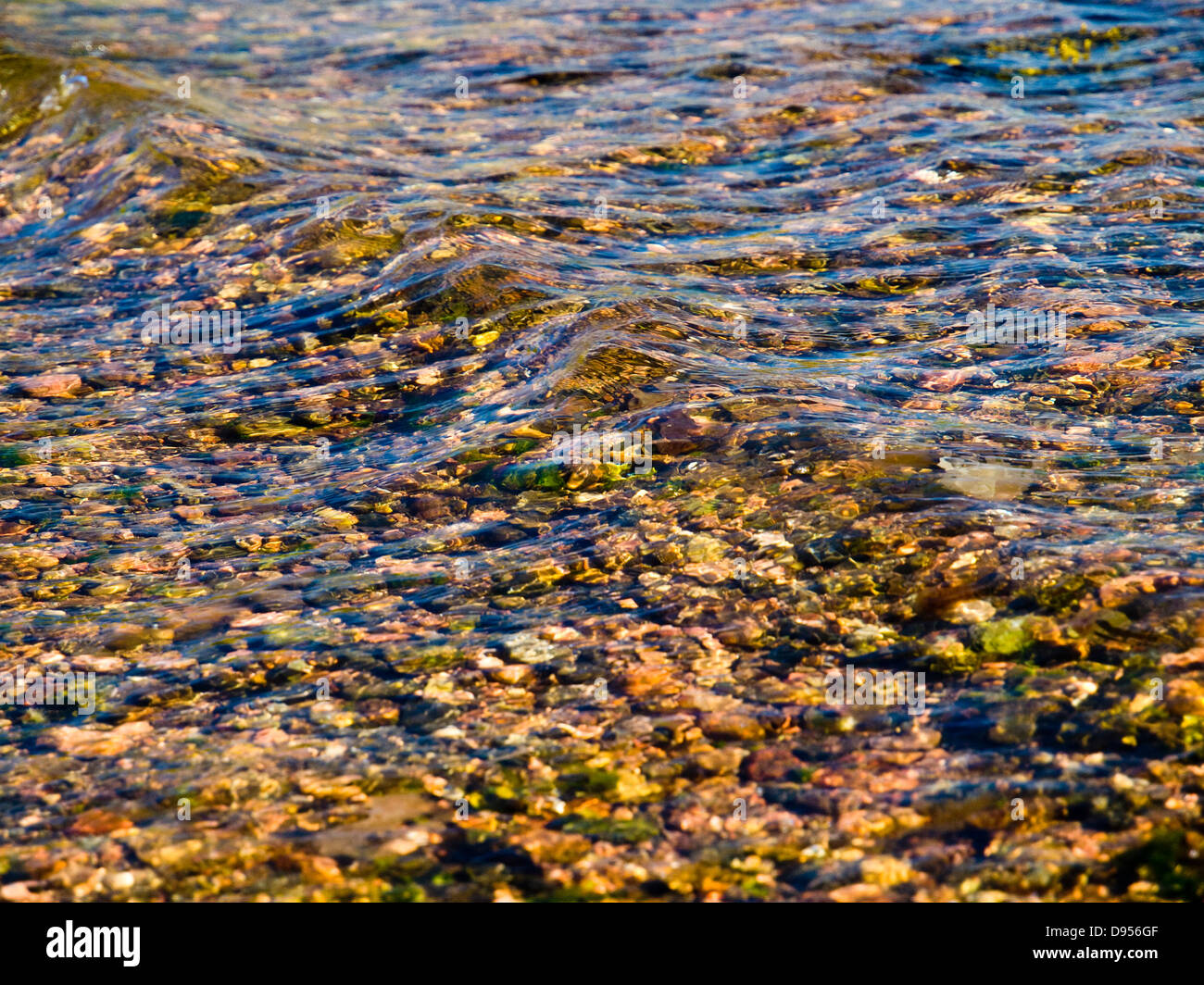 shallow sea washing over pebbles Stock Photo - Alamy