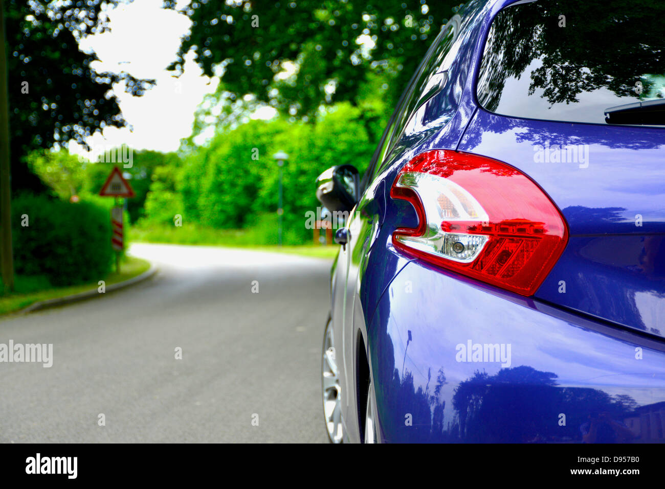 Blue Supercar On Forest Road Stock Photo - Alamy