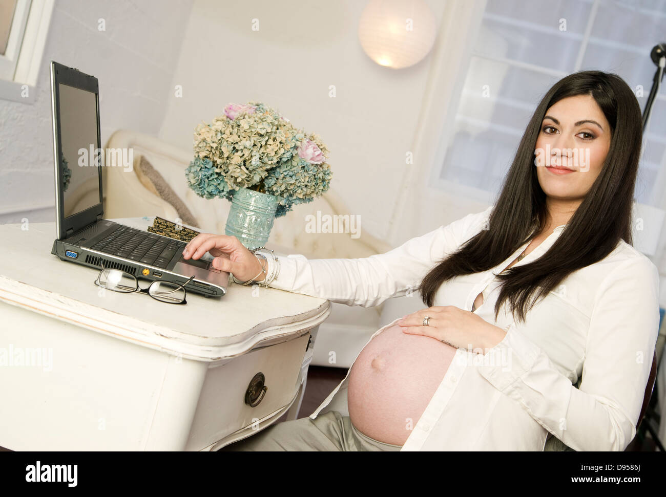 Woman work desk working at computer laptop while pregnant Stock Photo ...
