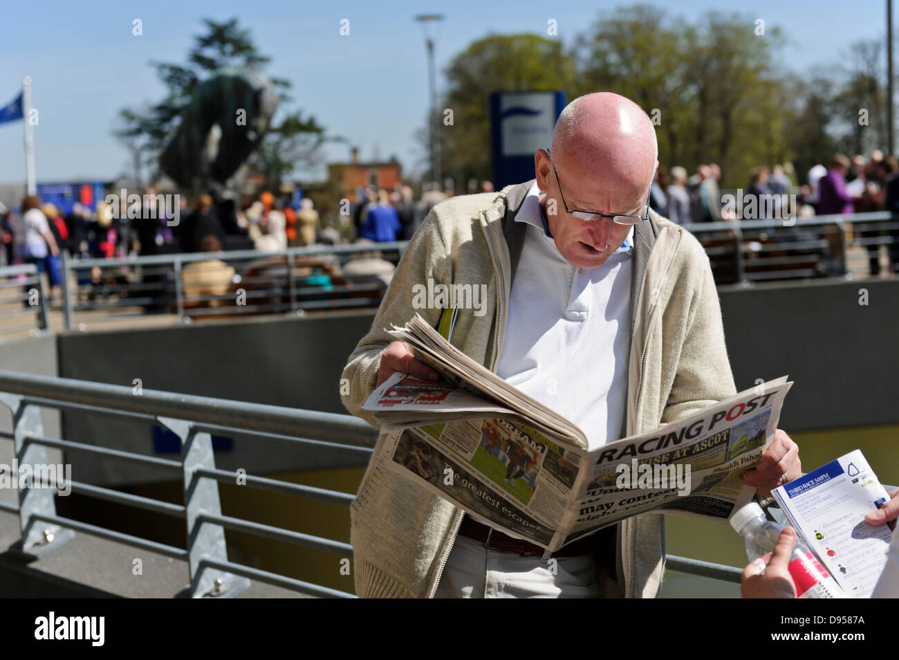Man reading racing information on newspaper, Ascot Racecourse, England ...