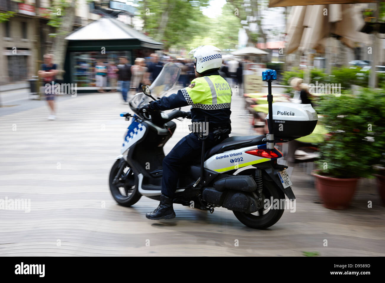 guardia urbana police officer on scooter patrolling la rambla city ...