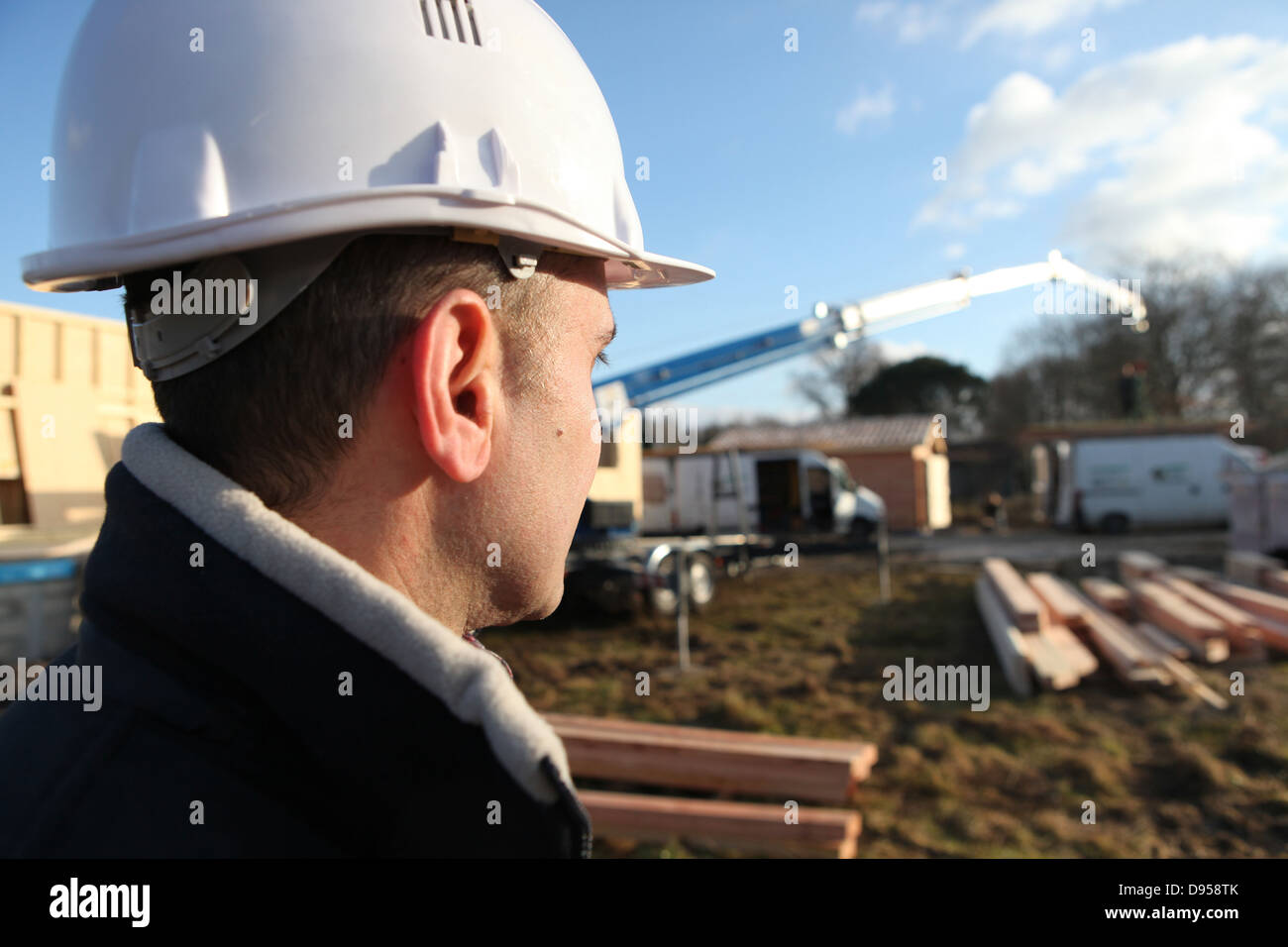 foreman in construction site with back turned to camera Stock Photo - Alamy