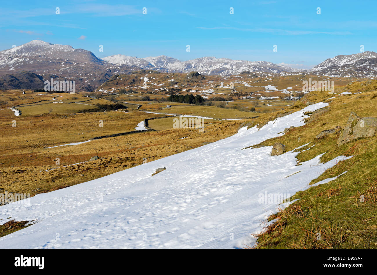 Snow covered Birker Fell and mountains near Birkerthwaite in Lake ...