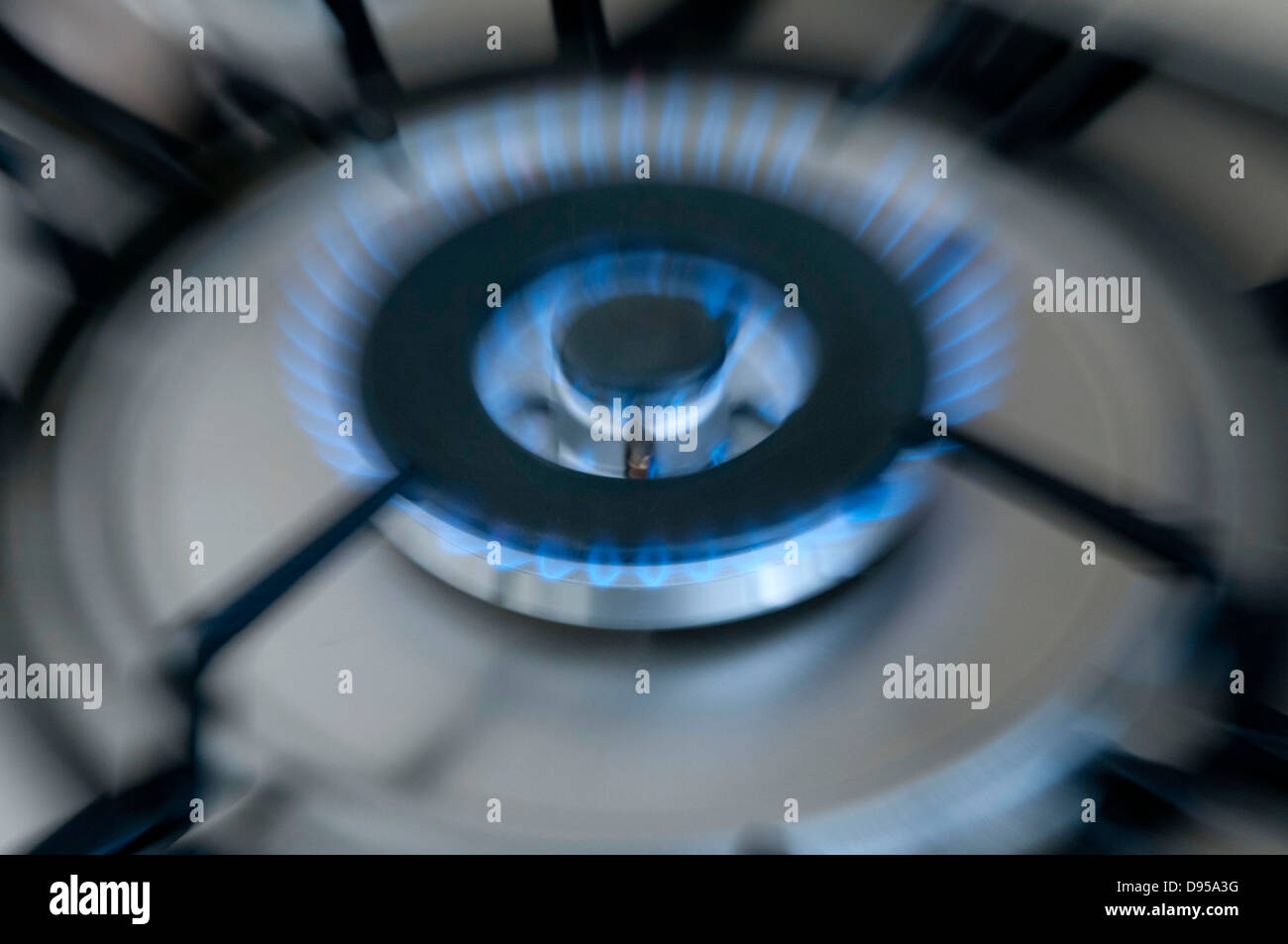 A lit gas ring alight on a stainless steel kitchen gas hob Stock Photo ...