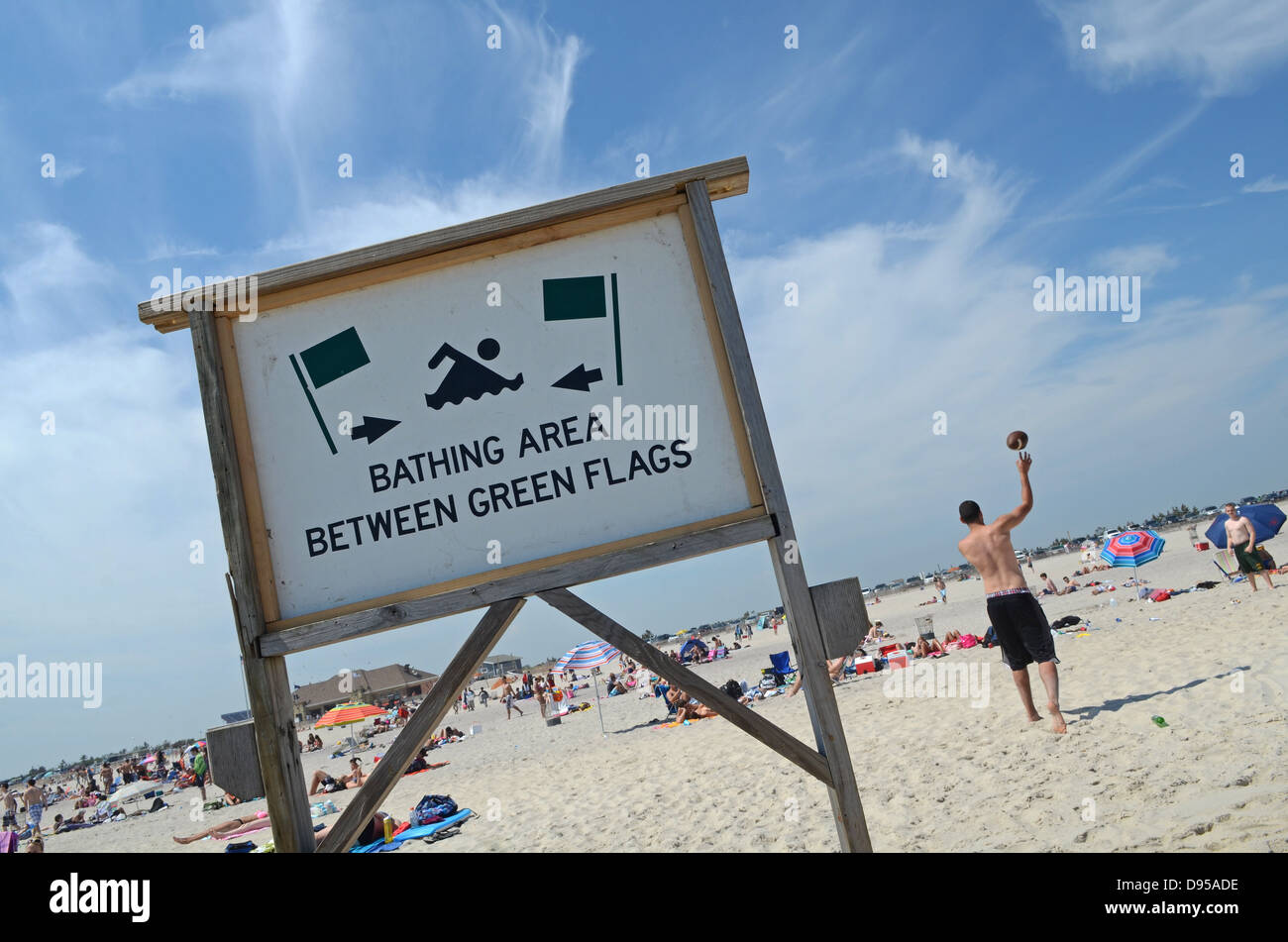 Sign reads "Bathing area between green flags" on Jones Beach State Park ...
