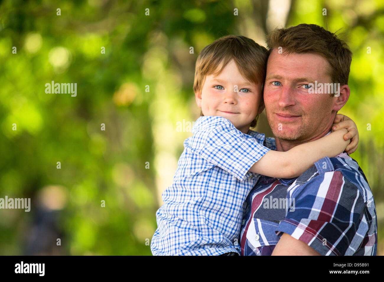Portrait of father and son outdoors Stock Photo - Alamy