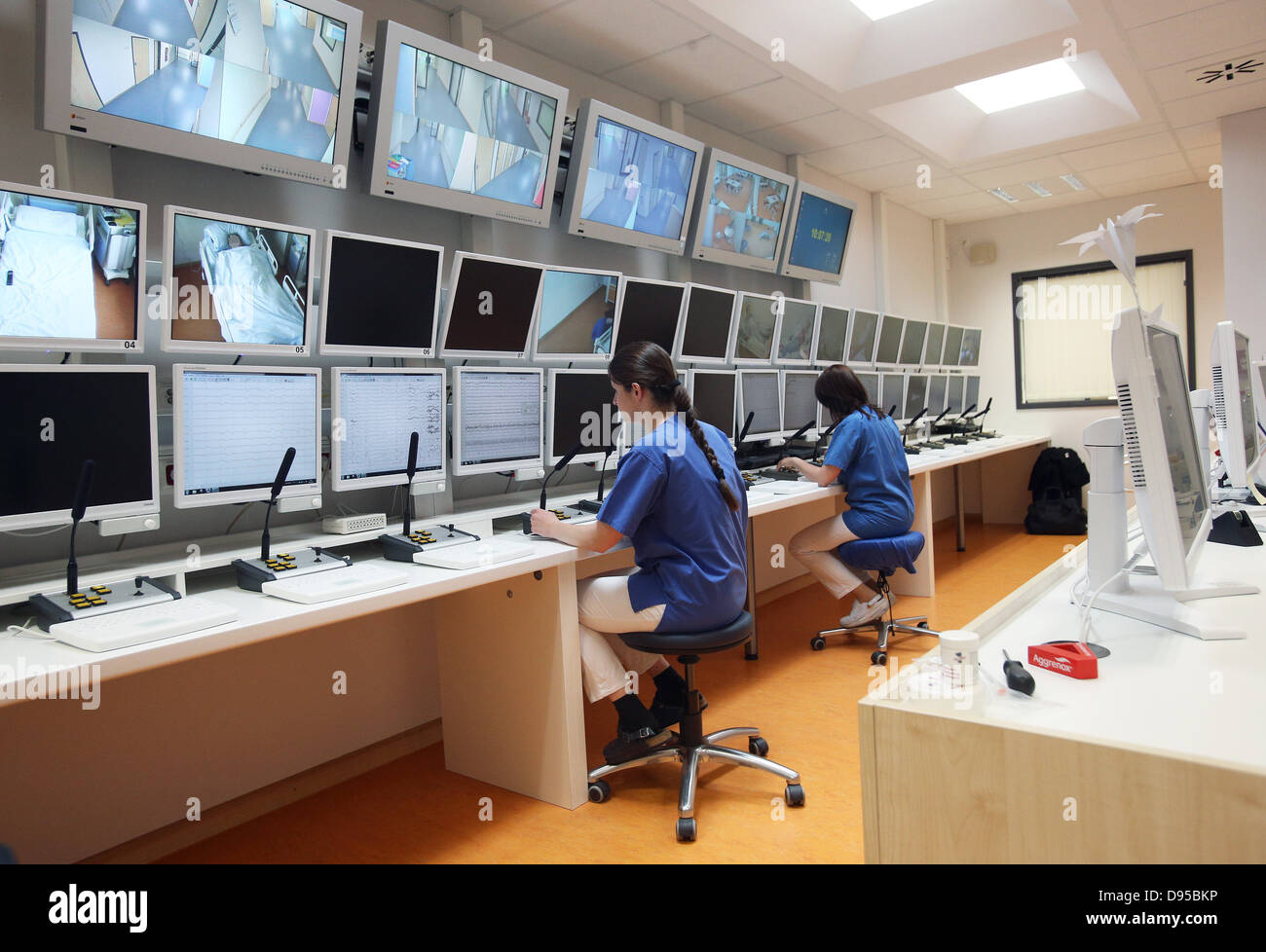 Two nurses watch patients on monitors in the new epilepsy monitoring ...