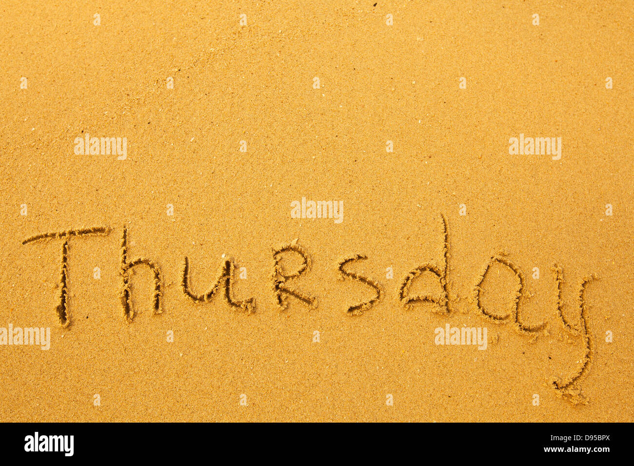Thursday - written in sand on beach texture Stock Photo - Alamy
