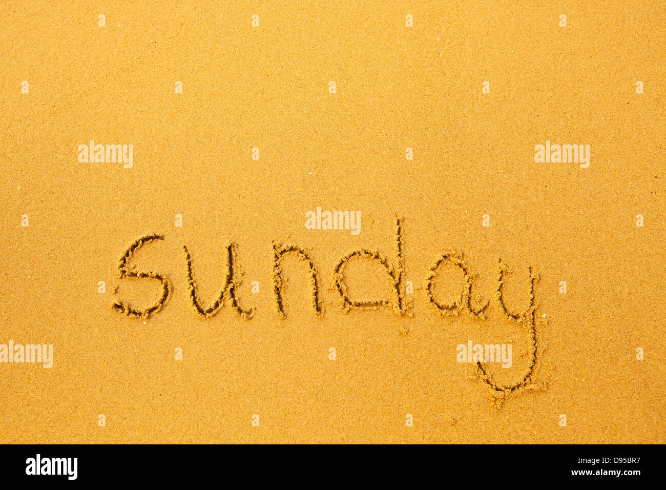 Sunday - written in sand on beach texture Stock Photo - Alamy