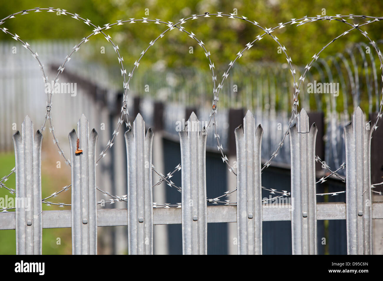 Spiked metal railings and razor wire around a secure compound Stock ...