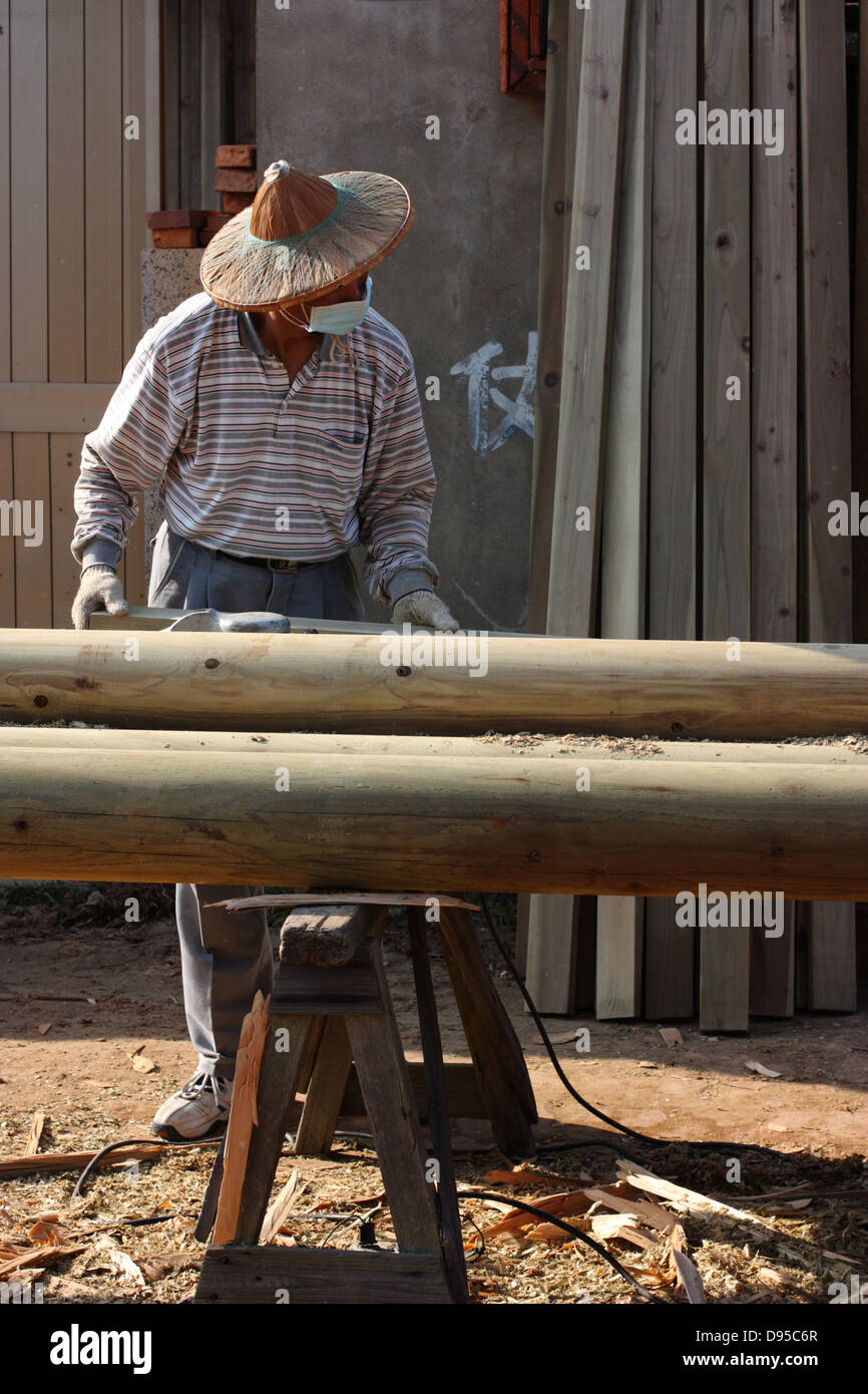A worker works on old traditional houses being restored. Kinmen ...