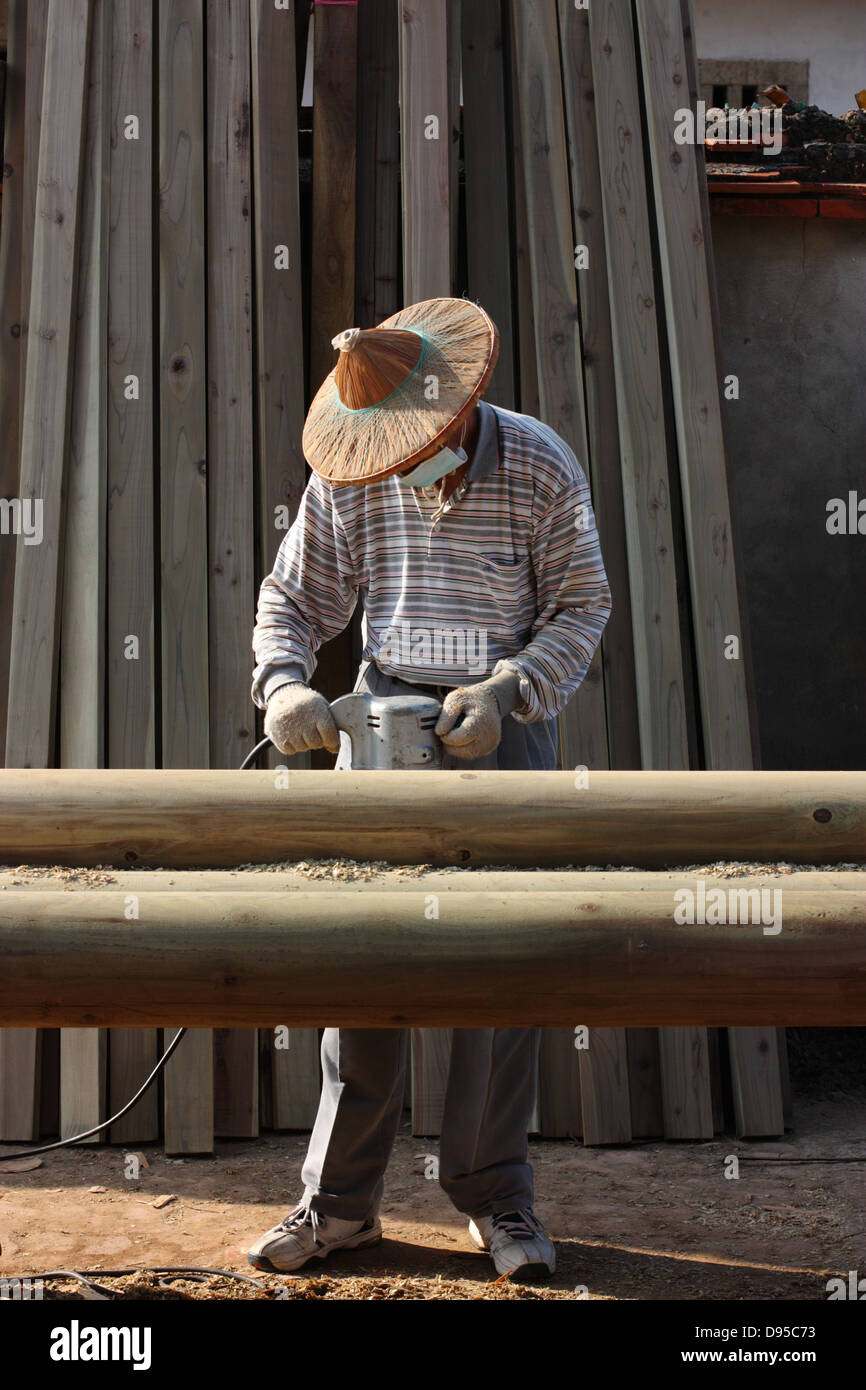 A worker works on old traditional houses being restored. Kinmen ...