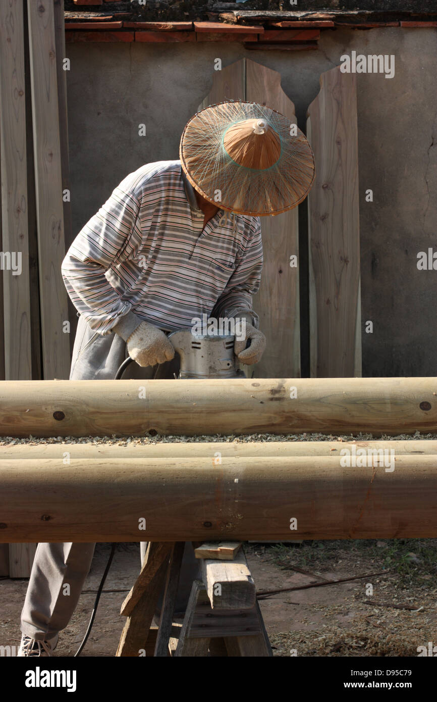 A worker works on old traditional houses being restored. Kinmen ...