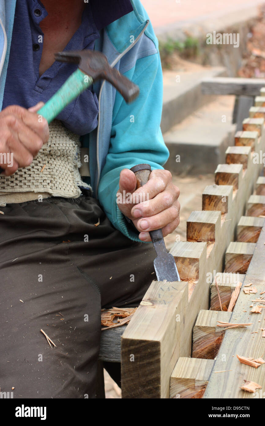 A worker works on old traditional houses being restored. Kinmen ...