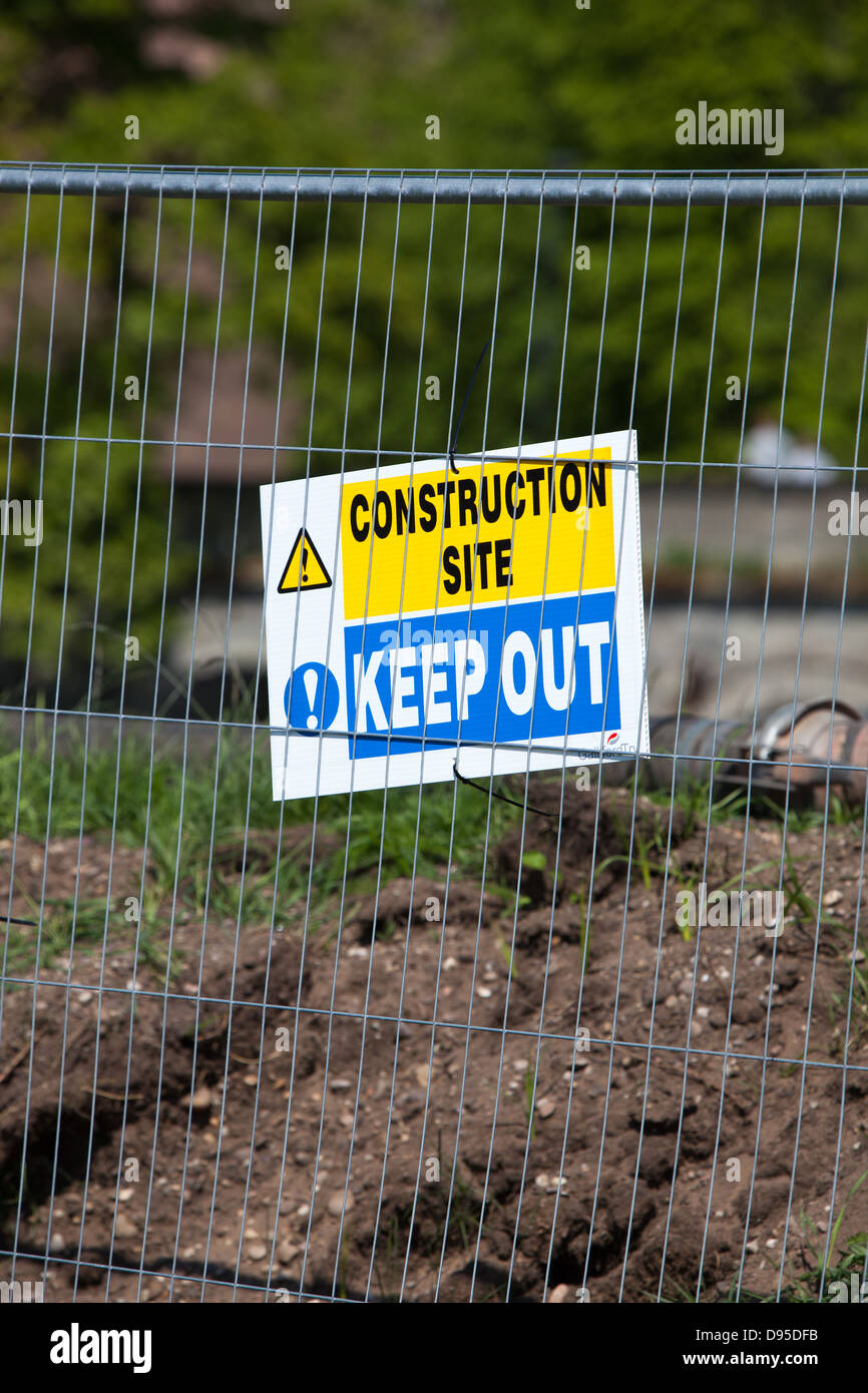 Warning notice on a fence around a construction site Stock Photo - Alamy