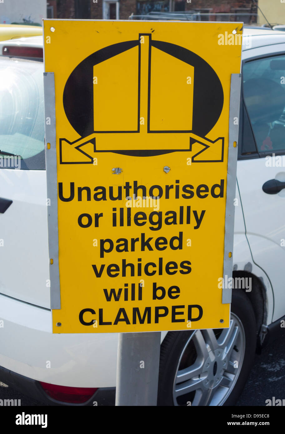 Wheel clamping sign in car park in UK Stock Photo - Alamy