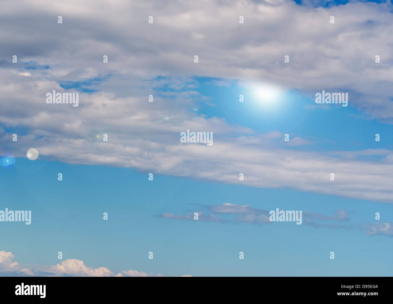 stratus clouds on a blue sky with sun Stock Photo - Alamy