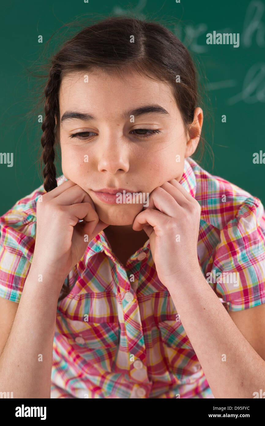 Close-up of Girl Leaning on Hands in Classroom Stock Photo - Alamy