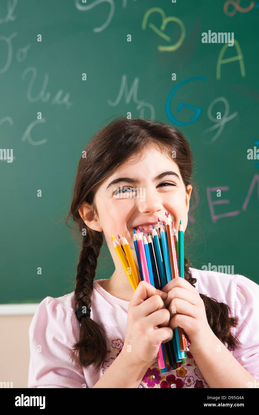 Girl Holding Coloured Pencils in Classroom, Baden-Wurttemberg, Germany ...