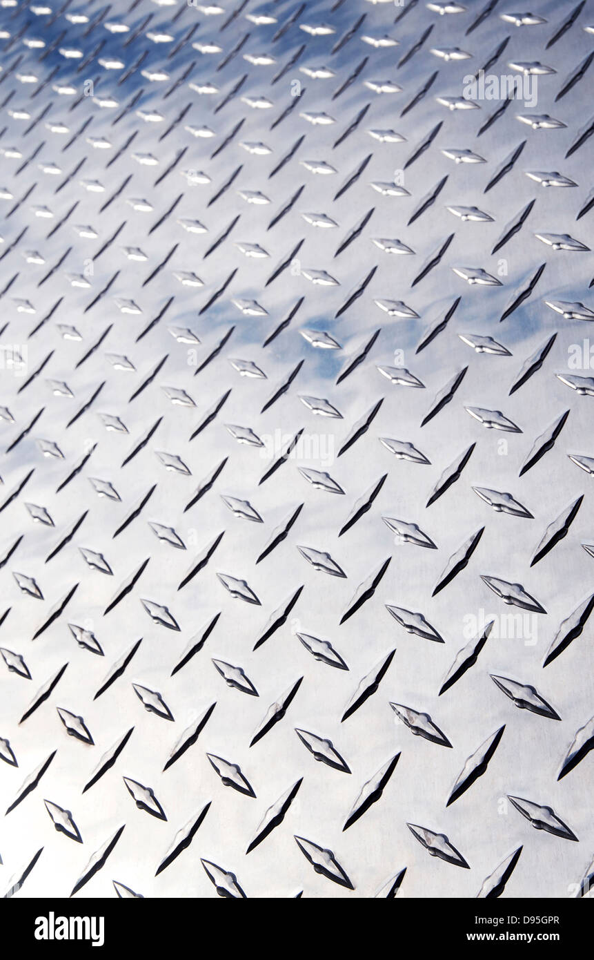 Low angle view of stainless steel diamond plate facade with reflection ...