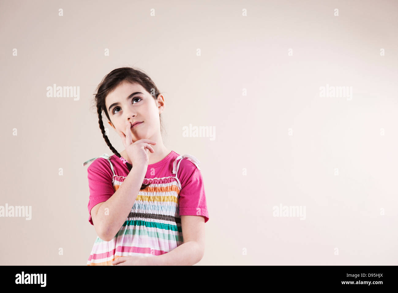 Portrait of Girl Looking up and Thinking in Studio Stock Photo - Alamy