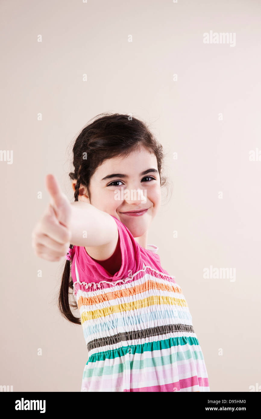 Portrait of Girl giving Thumbs Up in Studio Stock Photo - Alamy