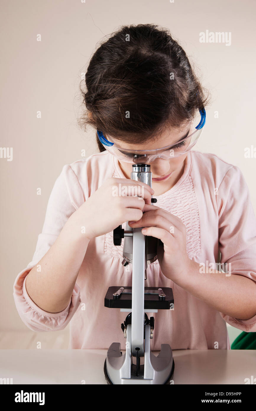 Girl wearing Safety Glasses looking into Microscope, Mannheim, Baden ...