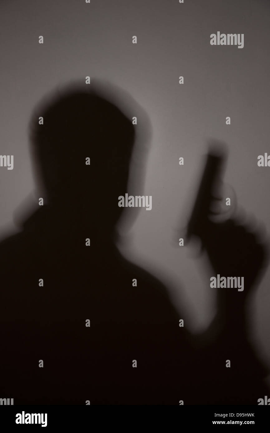 Image of man holding gun hi-res stock photography and images - Alamy