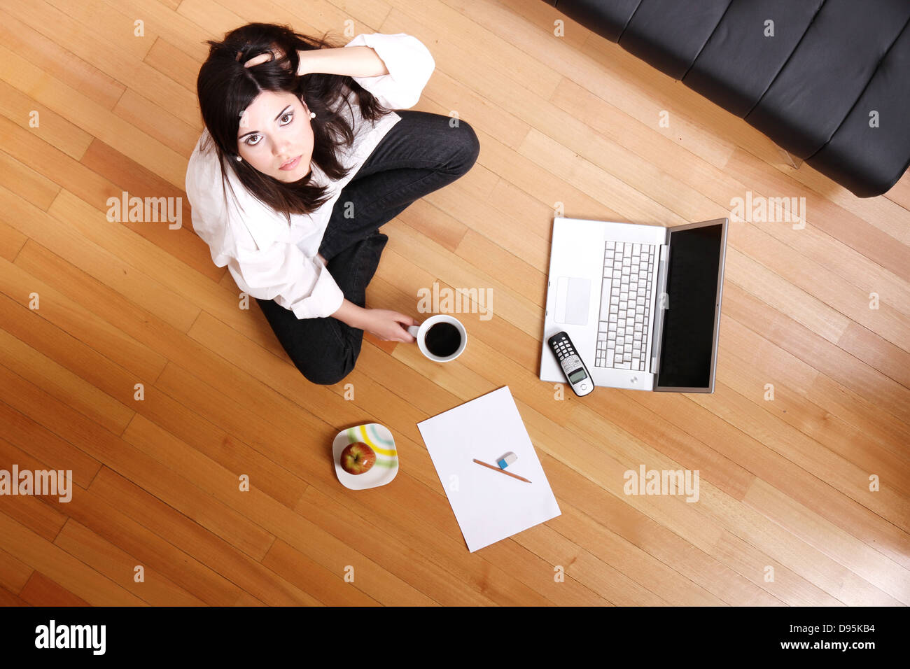 A young adult woman studying on the floor Stock Photo - Alamy