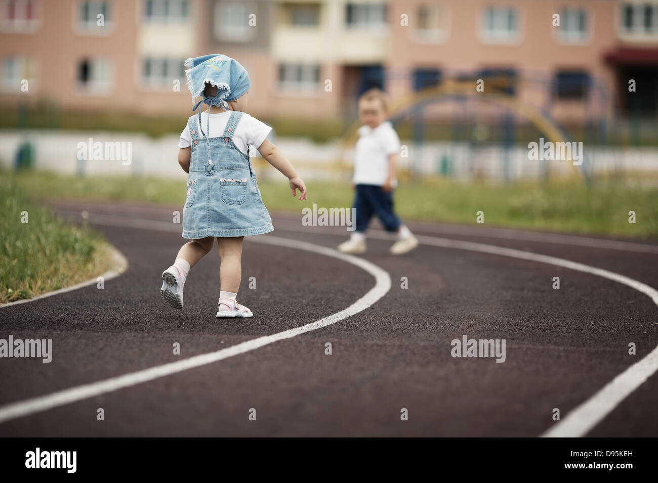 funny little children playing on stadium Stock Photo - Alamy