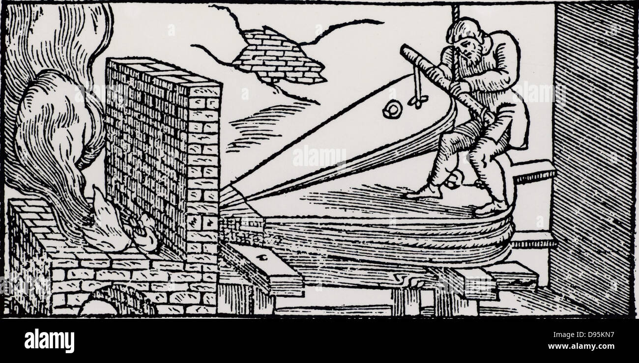 Man operating bellows to increase the draught to a furnace. From 'De la ...