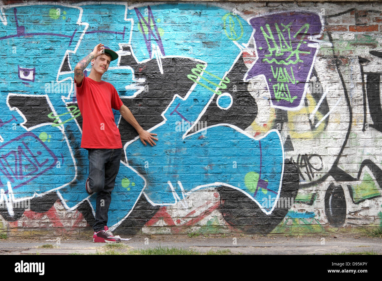 A greeting young Rapper greeting in front of a Graffiti wall Stock ...